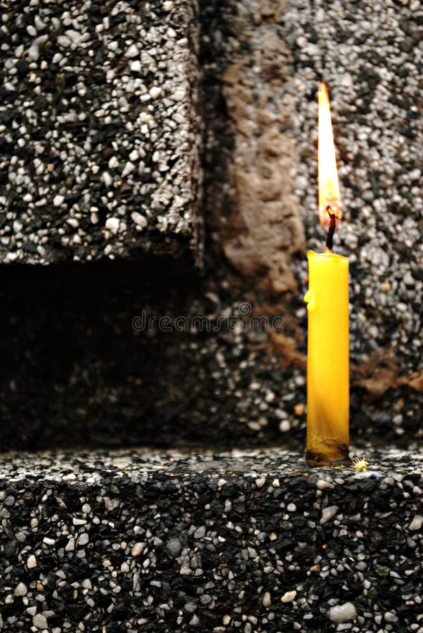 Yellow Candle With Dry Petals And White Flowers On A Gray Background ...