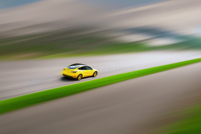 Yellow Car is Driving at High Speed on the Highway with a Speed Blur ...
