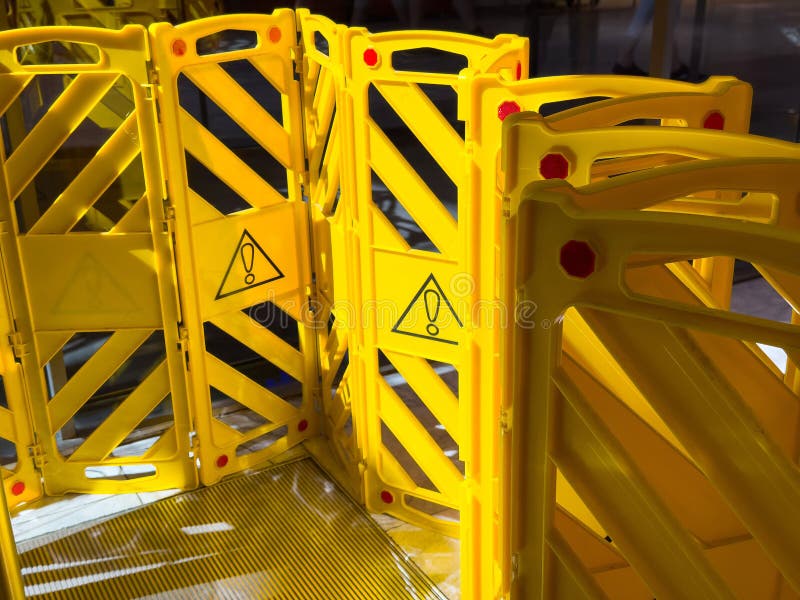 Yellow Caution Barrier with Warning Symbols in Public Area Editorial ...