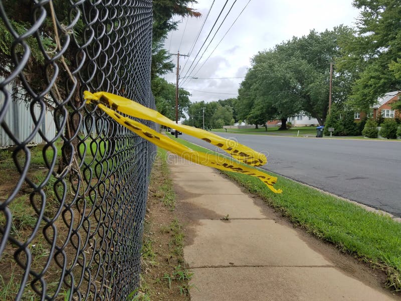 Yellow Caution Tape on Chain Link Fence and Sidewalk and Road Stock ...