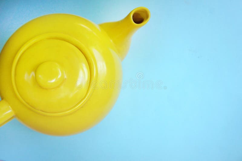 Yellow Ceramic Teapot . Top View. Teapot on Pastel Blue Background in ...