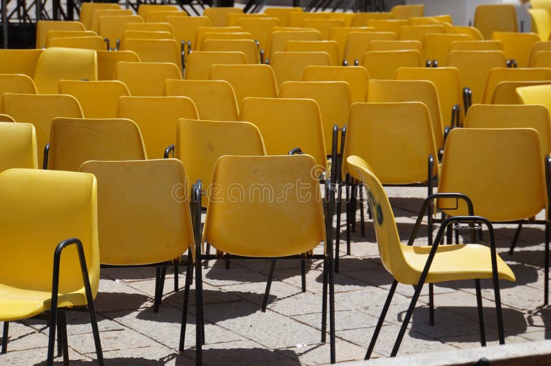 Yellow chairs parade stock photo. Image of line, seats - 95352034