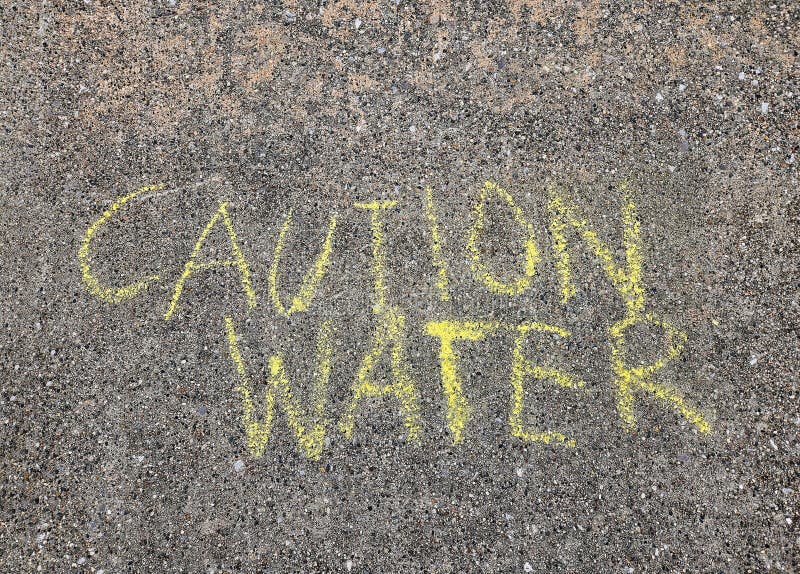 Yellow Chalk Caution Sign on Concrete Stock Image - Image of water ...
