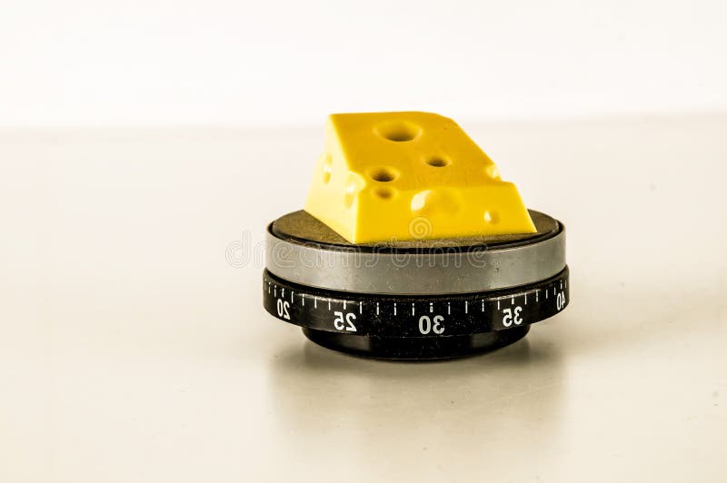 A Yellow Cheese Wedge Sits on Top of a Clock Face Stock Image - Image ...