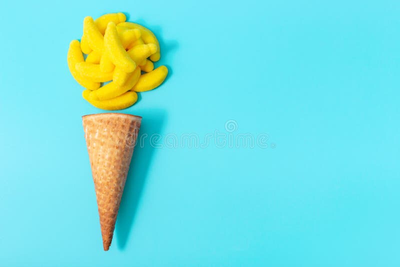 Yellow Chewing Candy with Waffle Cone on the Blue Background, Copy ...