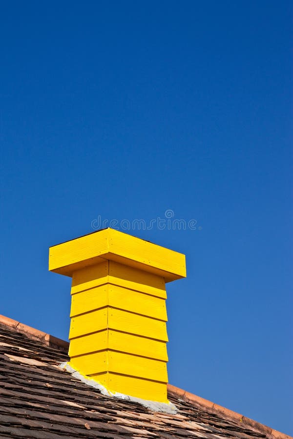 Yellow Chimney and Blue Sky Stock Image - Image of roof, yellow: 11910733