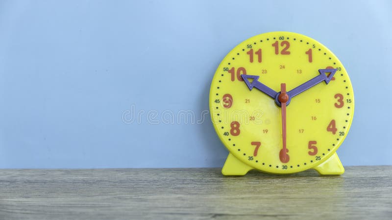 Yellow Clock Against a Blue Background with Copy Space Stock Image ...