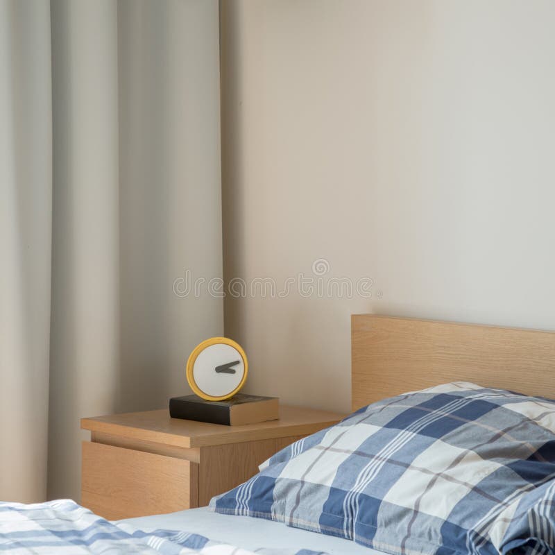 Yellow Clock on Wooden Bedside Table Stock Photo - Image of house ...