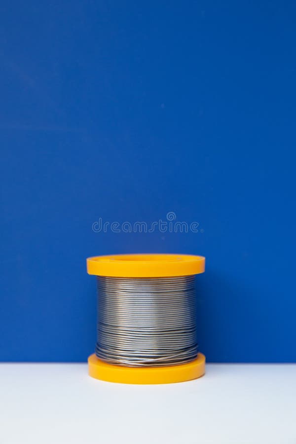 A Yellow Coil of Solder Stands in the Frame. the Coil Stands on the ...
