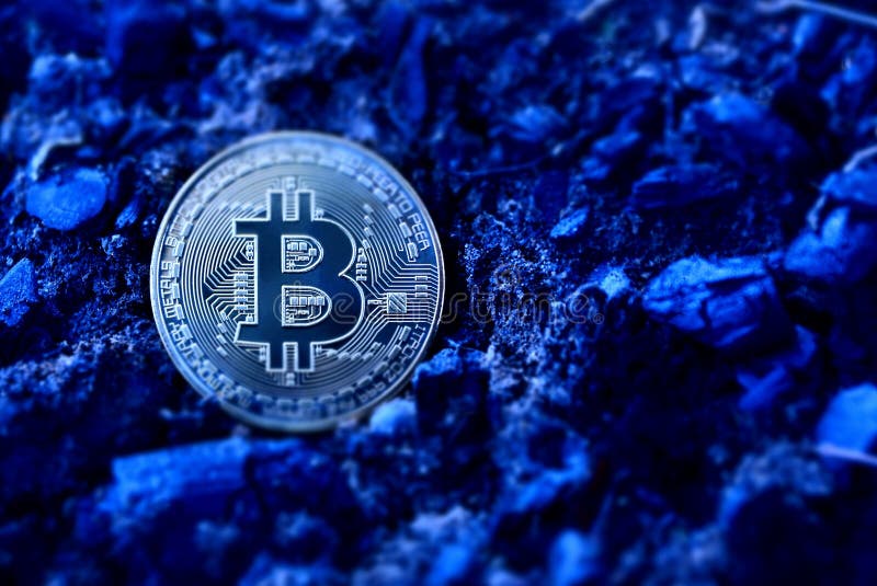 The Yellow Coin Lies on the Black Blue Earth Stock Photo - Image of ...