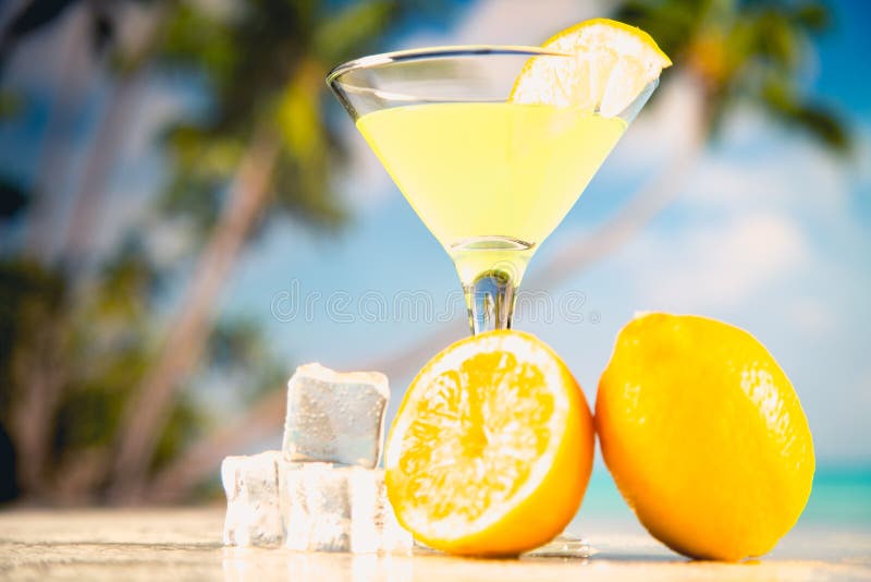 Yellow Cold Drink on a Beach with Lemon and Ice Stock Image - Image of ...