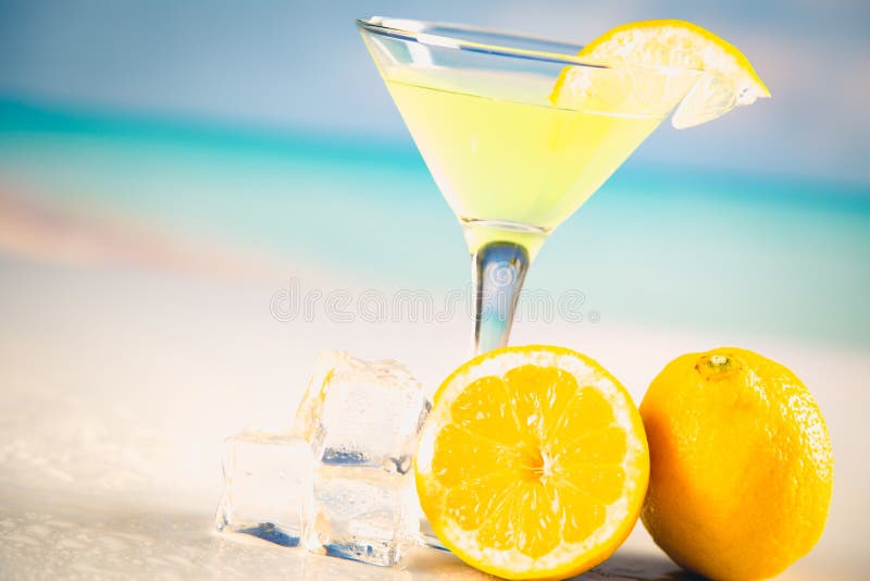 Yellow Cold Drink on a Beach with Lemon and Ice Stock Image - Image of ...