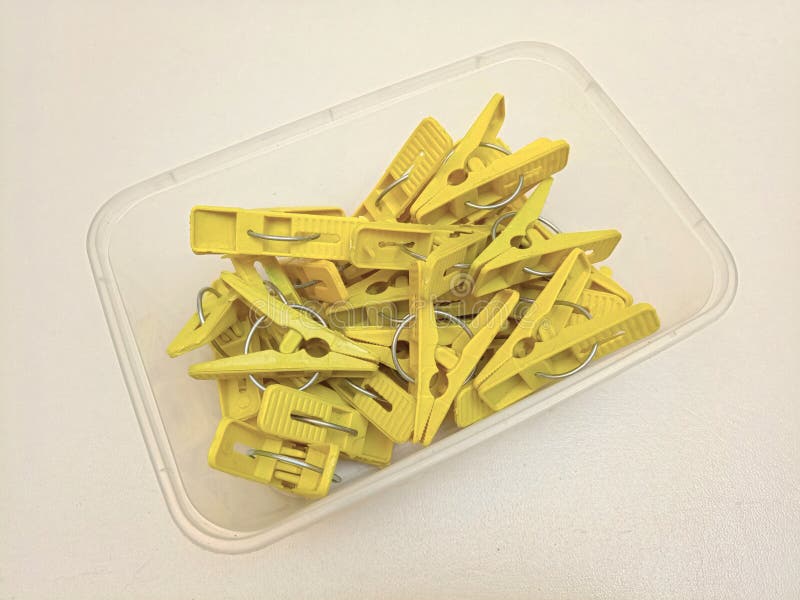 Yellow Color Laundry Clips in a Container on the White Background ...