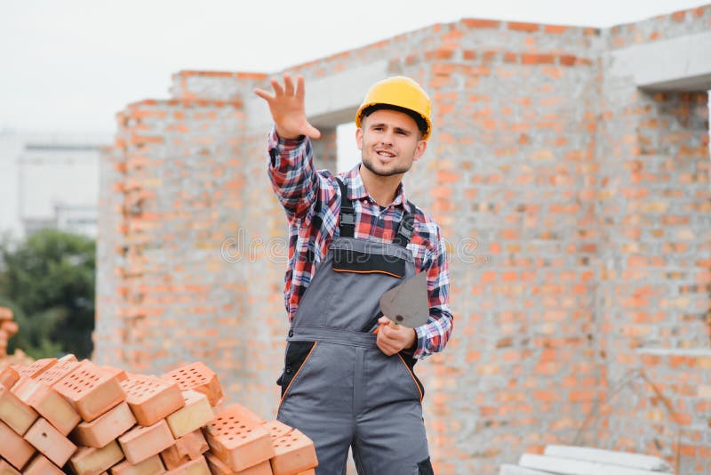 Yellow Colored Hard Hat. Young Man Working in Uniform at Construction ...