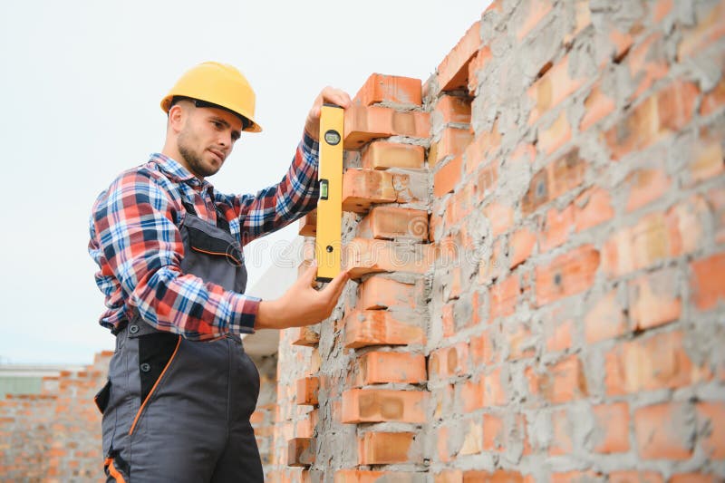 Yellow Colored Hard Hat. Young Man Working in Uniform at Construction ...