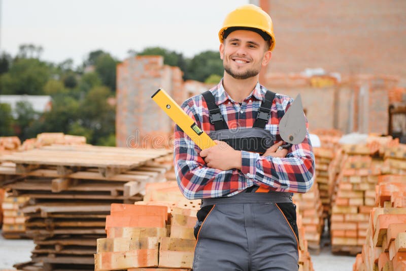 Yellow Colored Hard Hat. Young Man Working in Uniform at Construction ...