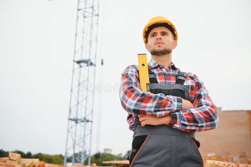 Yellow Colored Hard Hat. Young Man Working in Uniform at Construction ...