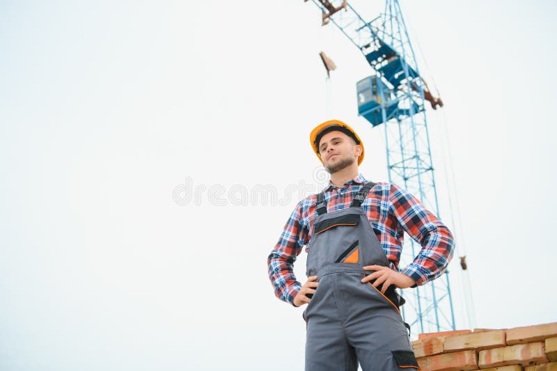 Yellow Colored Hard Hat. Young Man Working in Uniform at Construction ...