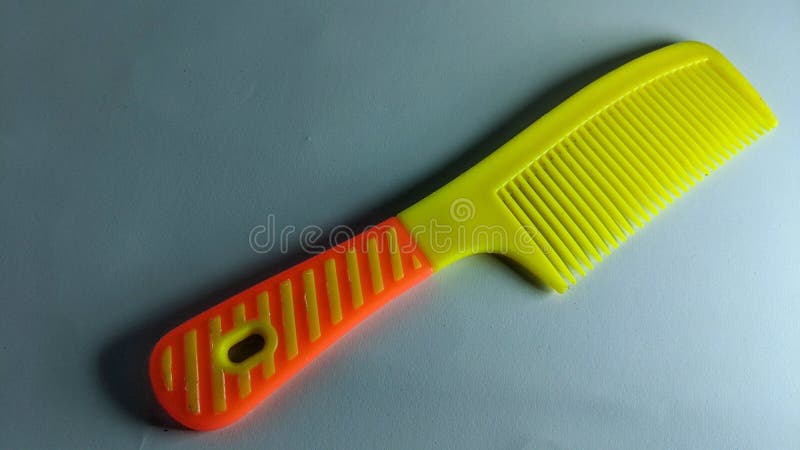 A Yellow Comb with an Orange Handle. the Comb Has a Wide, Rectangular ...