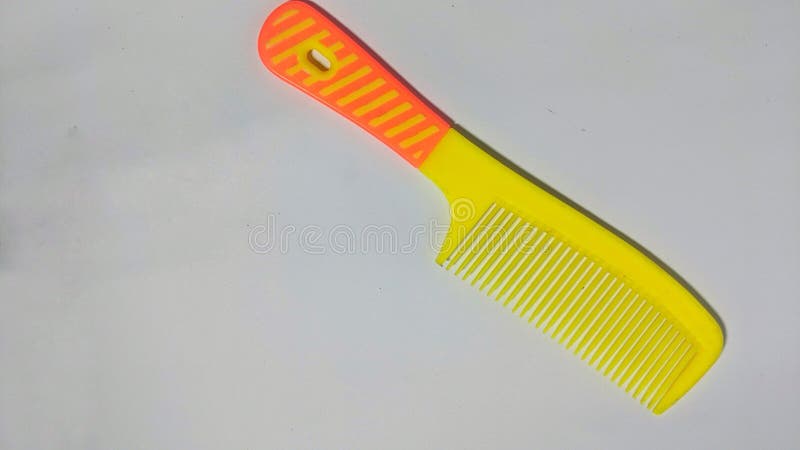 A Yellow Comb with an Orange Handle. the Comb Has a Wide, Rectangular ...