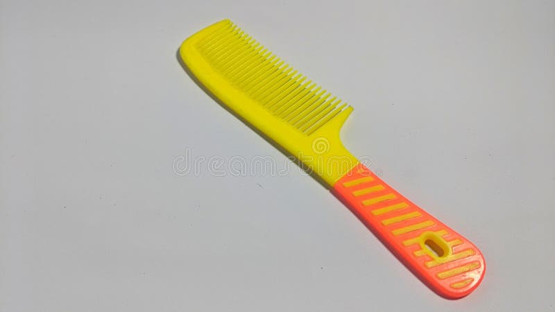 A Yellow Comb with an Orange Handle. the Comb Has a Wide, Rectangular ...