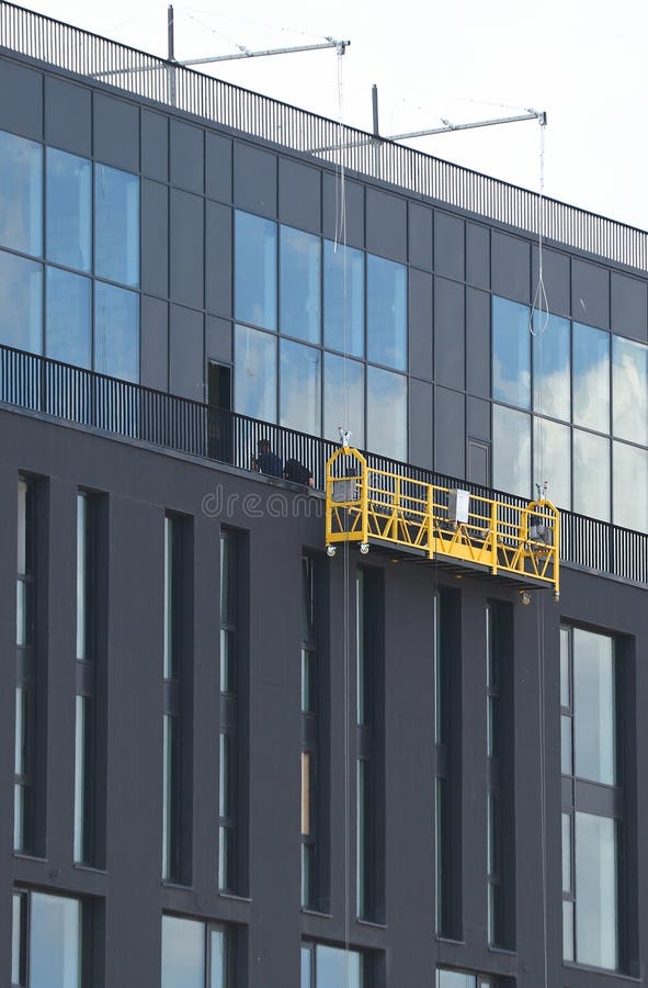 Yellow Construction Cradle on the Wall of the Building Stock Image ...