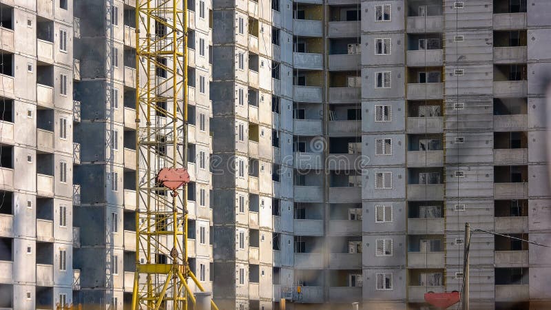 Yellow Construction Crane and New High-rise Building. Stock Image ...