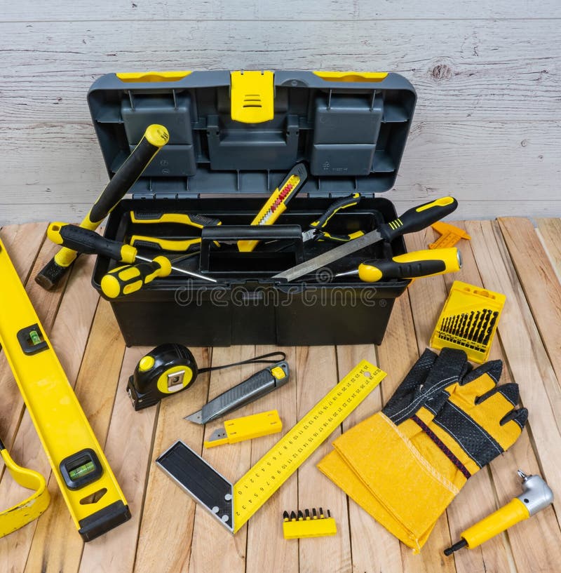 Yellow Construction Instruments and a Tool Box on a Wooden Background ...