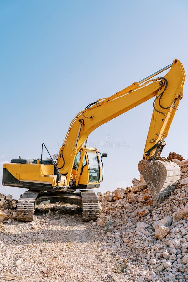 Yellow Crawler Excavator Digging Rocky Soil Stock Image - Image of ...