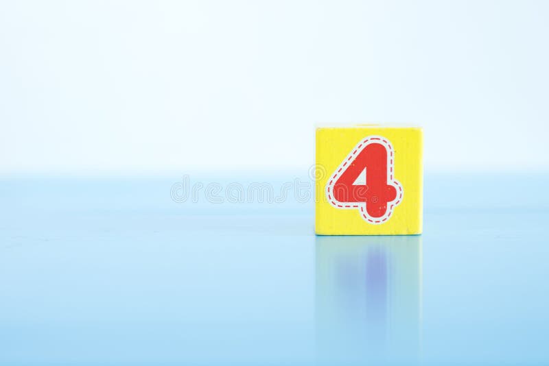 Yellow Cube with the Number 4 on it Isolated on a Blue Gradient ...