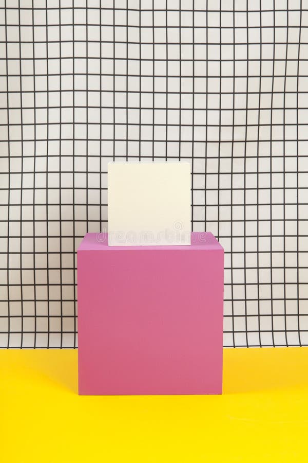 A Yellow Cube on Top of a Larger Pink Cube Balanced on a Black and ...