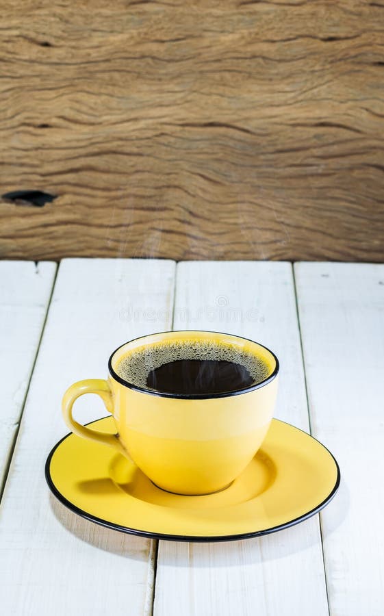 Yellow Cup of Hot Coffee on the Table White Wood Stock Photo - Image of ...
