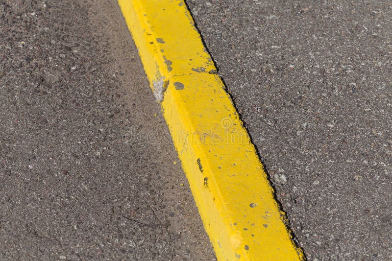 Yellow curb stone border stock photo. Image of earth - 280093052