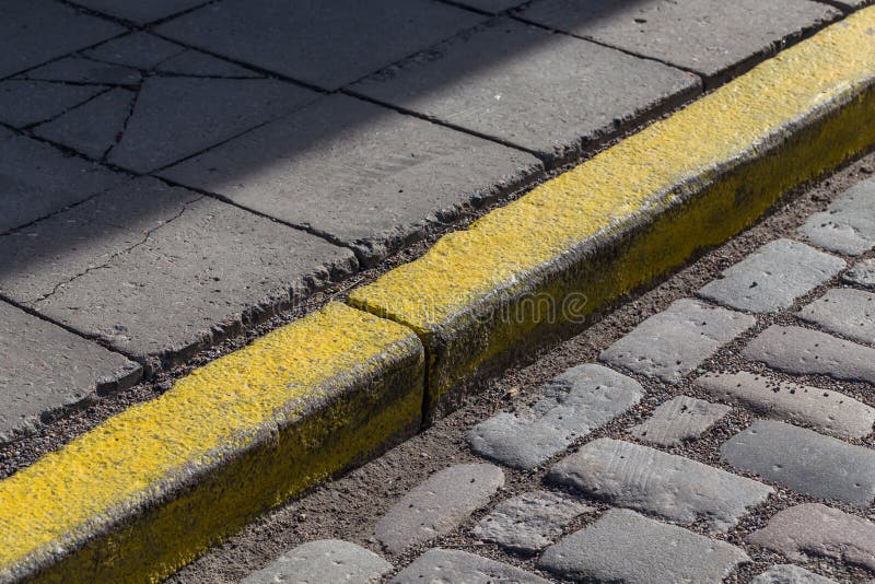 Yellow curb stone border stock photo. Image of rough - 56477450