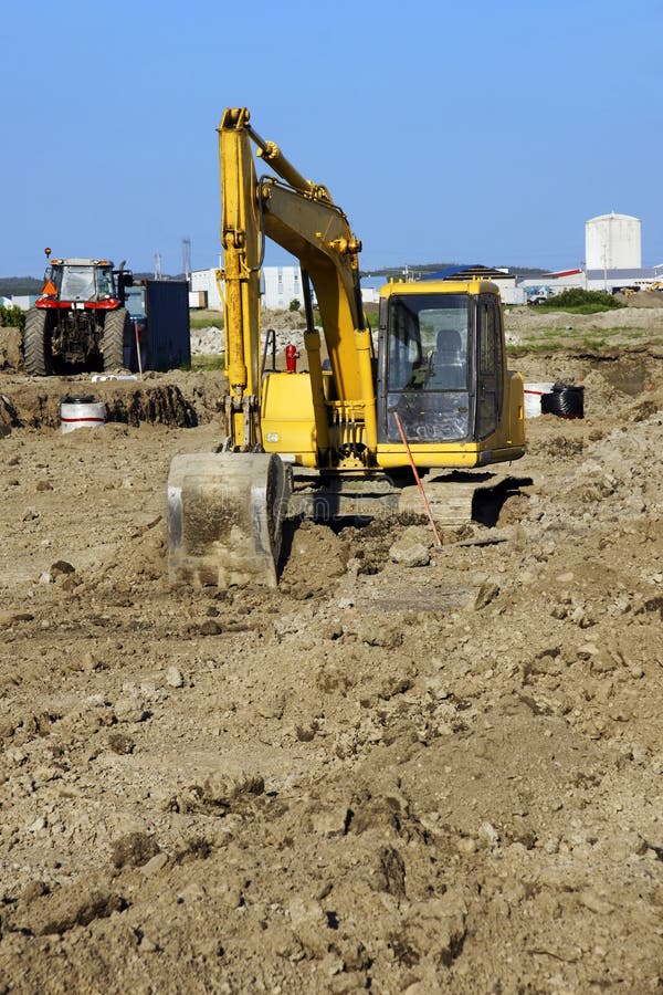 Yellow Digger and Tractor Vertical Stock Image - Image of dirt ...