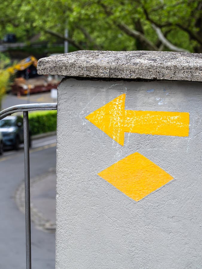 Yellow Directional Arrow and Diamond on Wall Stock Image - Image of ...