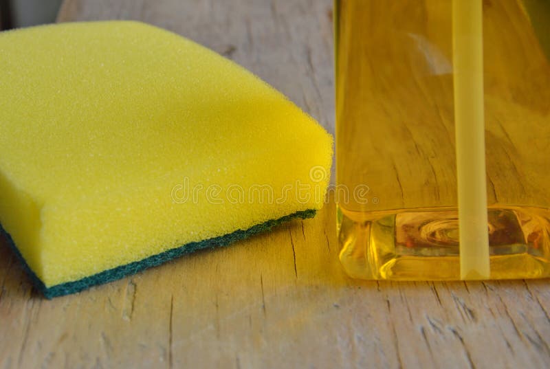Yellow Dish Washing Soap and Scrub Sponge on Wooden Board Stock Photo ...