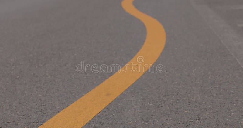 Yellow Dividing Strip on an Asphalt Road. Dashed Line Changes To Solid ...
