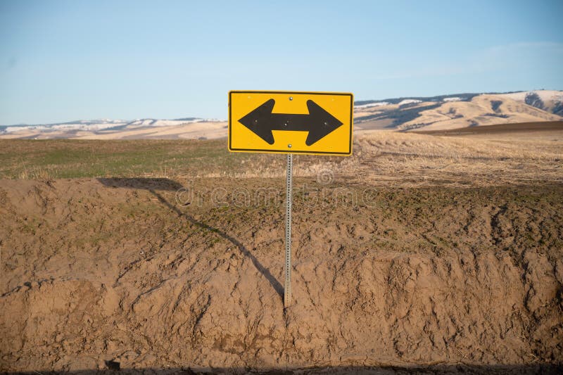 Yellow Double Arrow Sign in the Desert Stock Photo - Image of direction ...