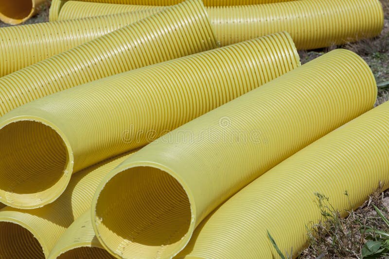 Yellow drain pipe stock image. Image of grass, construction - 98016913