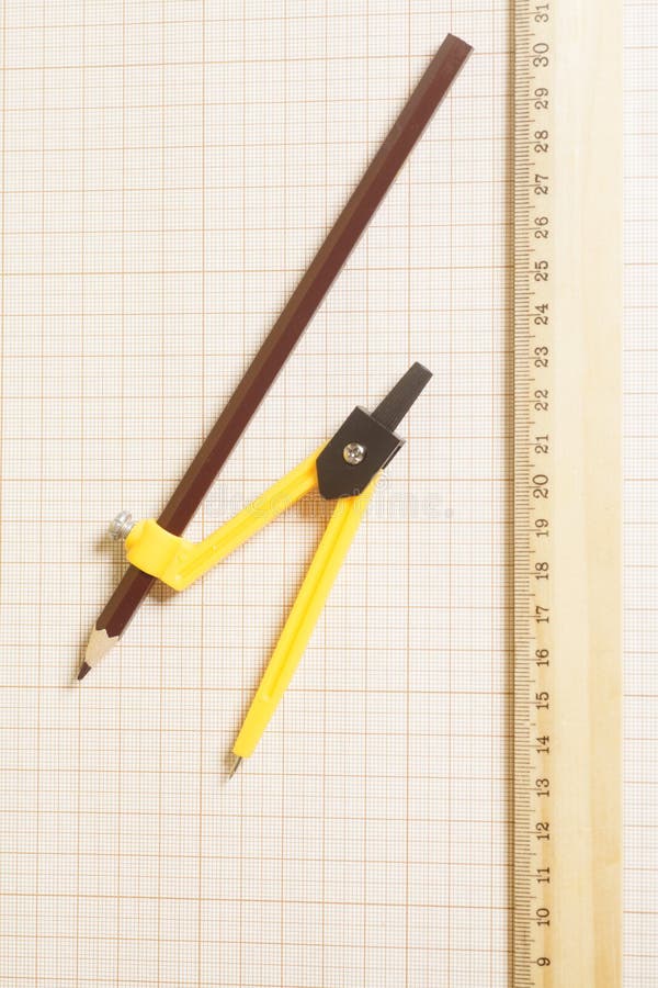 Yellow Drawing Compass with Pensil and Rulers on Graph Paper.En Stock ...