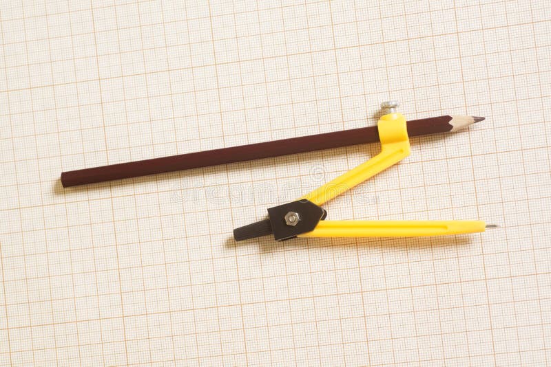 Yellow Drawing Compass with Pensil and Rulers on Graph Paper.En Stock ...