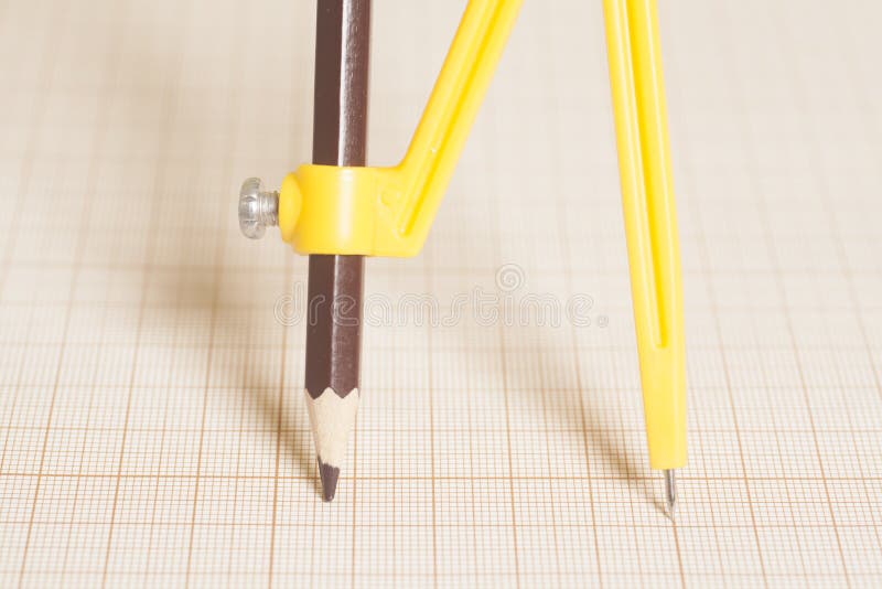Yellow Drawing Compass with Pensil and Rulers on Graph Paper.En Stock ...