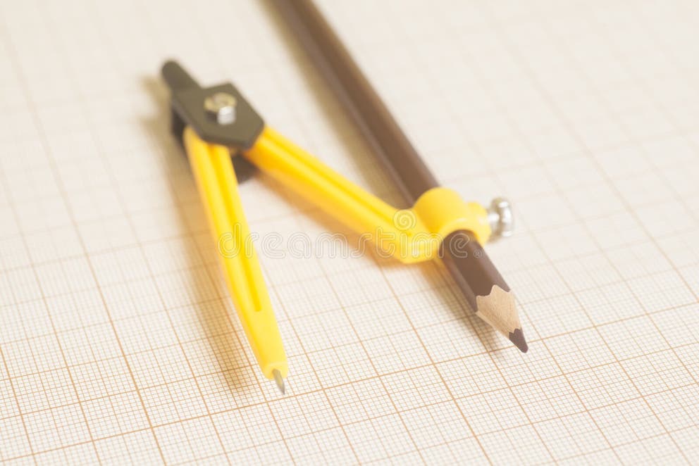 Yellow Drawing Compass on Graph Paper Stock Image - Image of ideas ...