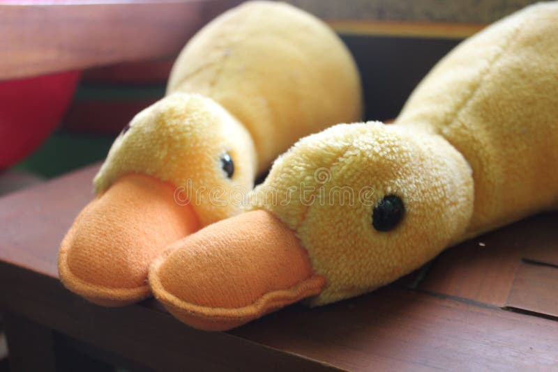 Yellow Ducks, Stuffed Animals, Getting Along on a Wooden Table Stock ...