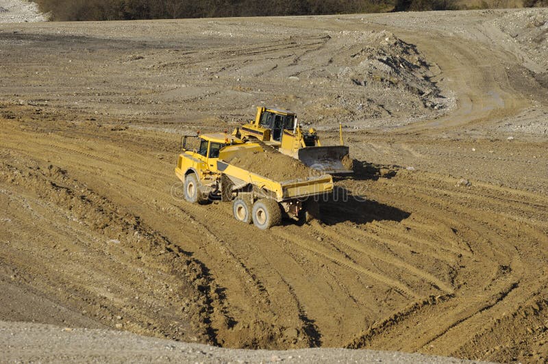 Yellow Dump Truck Working in Gravel Pit Stock Photo - Image of dozer ...