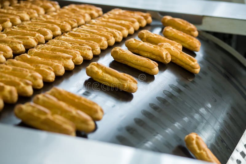 Yellow Eclair Shells on Conveyor. Stock Image - Image of recipe ...