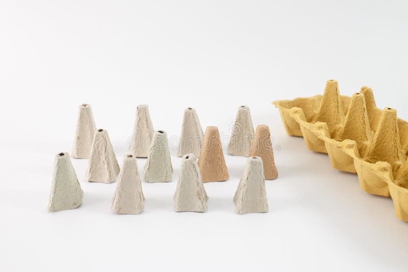 A Yellow Egg Carton with Several Individual Cone-shaped Pieces of the ...