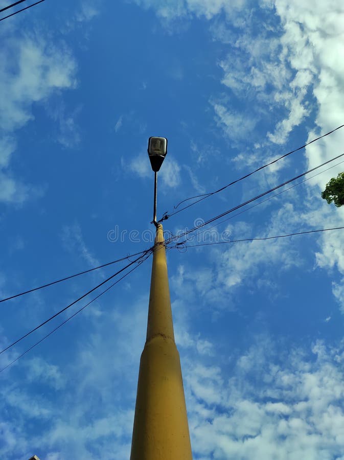 A Yellow Electric Pole with a Street Lamp on it Stock Image - Image of ...