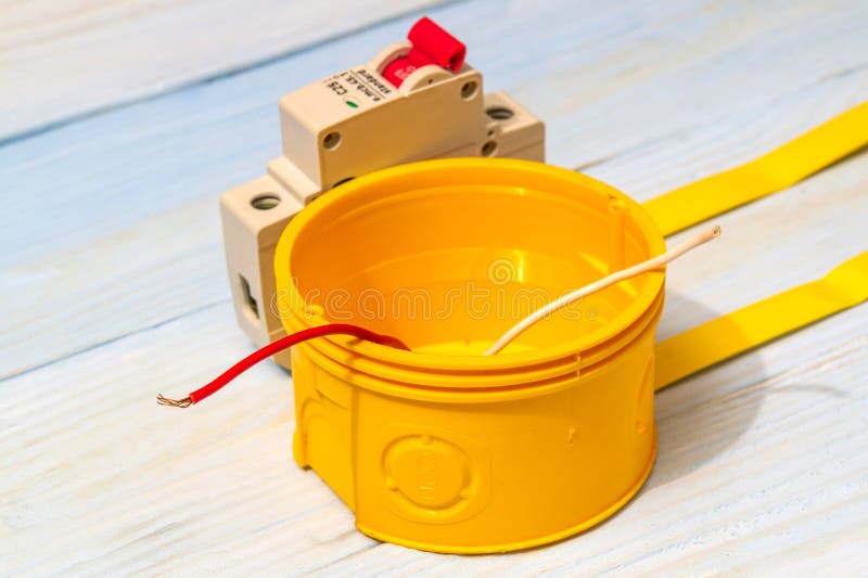 Yellow Electrical Junction Box and Circuit Breaker with Wires on Blue ...